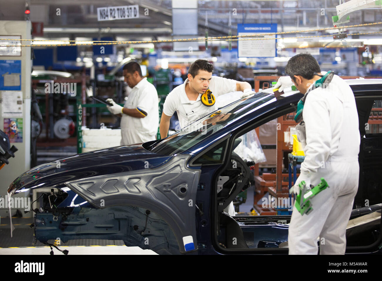 Workers in the golf vehicle section of the Volkswagen factory in Puebla ...