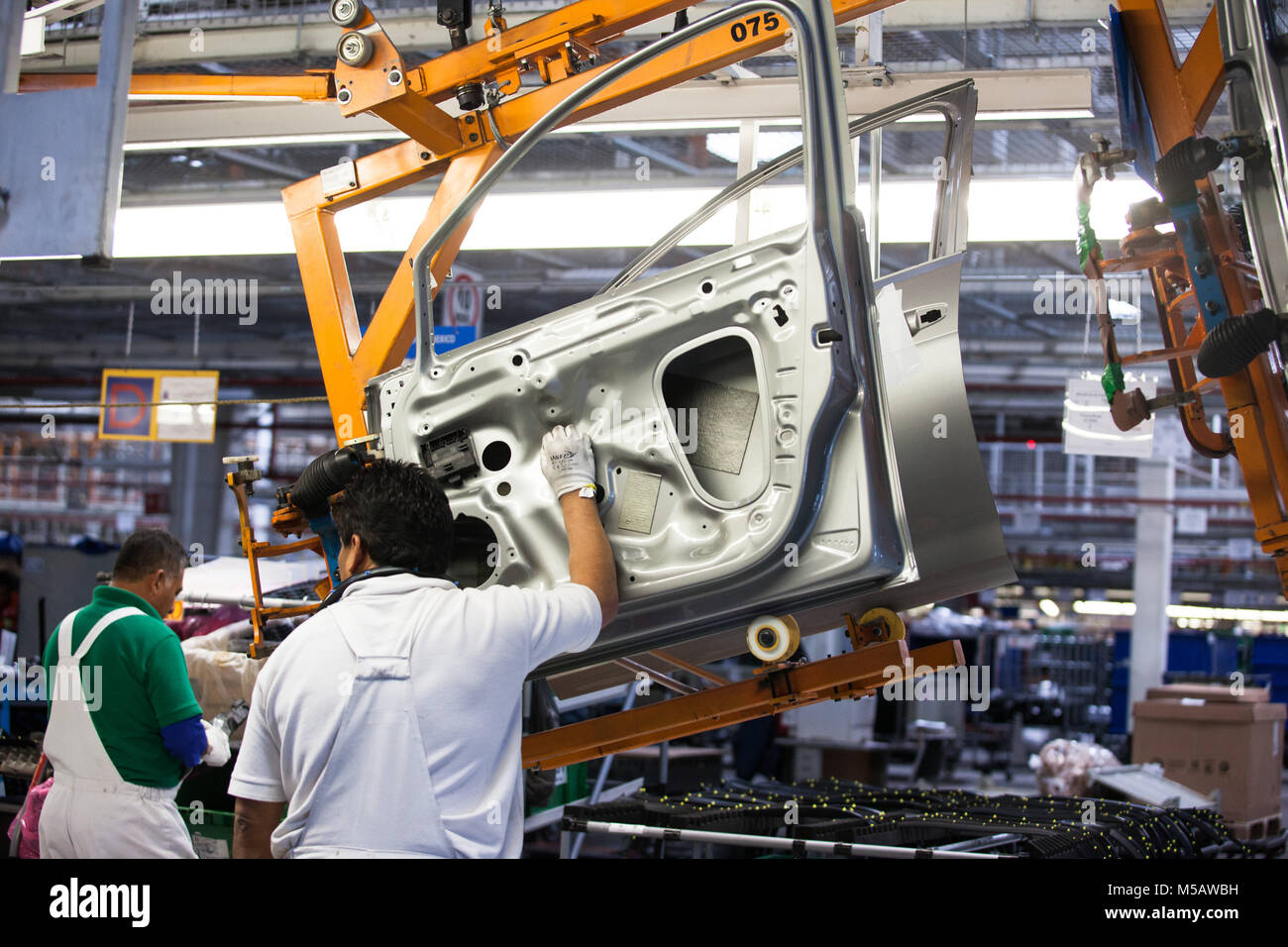 Workers in the golf vehicle section of the Volkswagen factory in Puebla ...