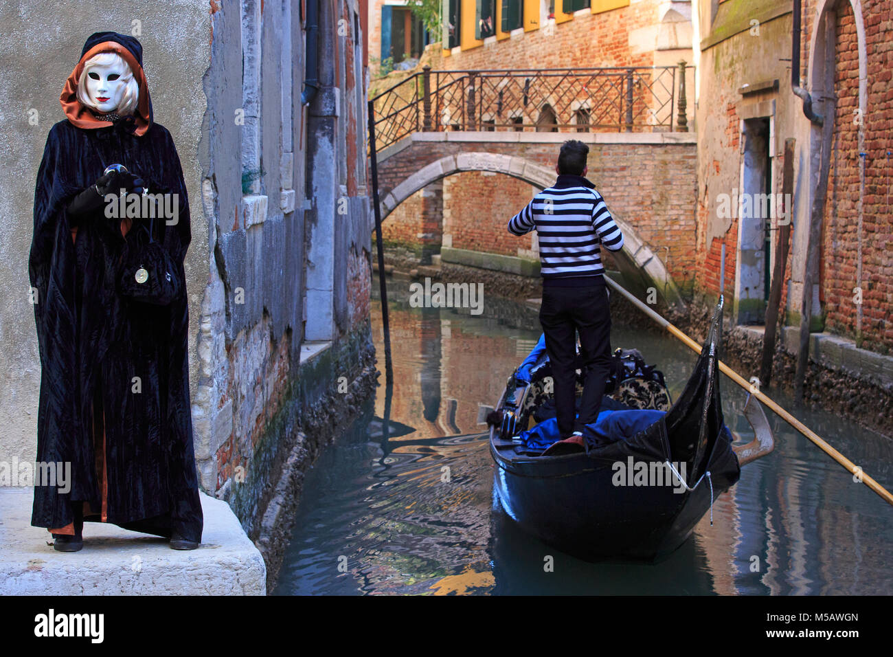 A gondolier rowing past a female fortune teller during the Carnival of ...