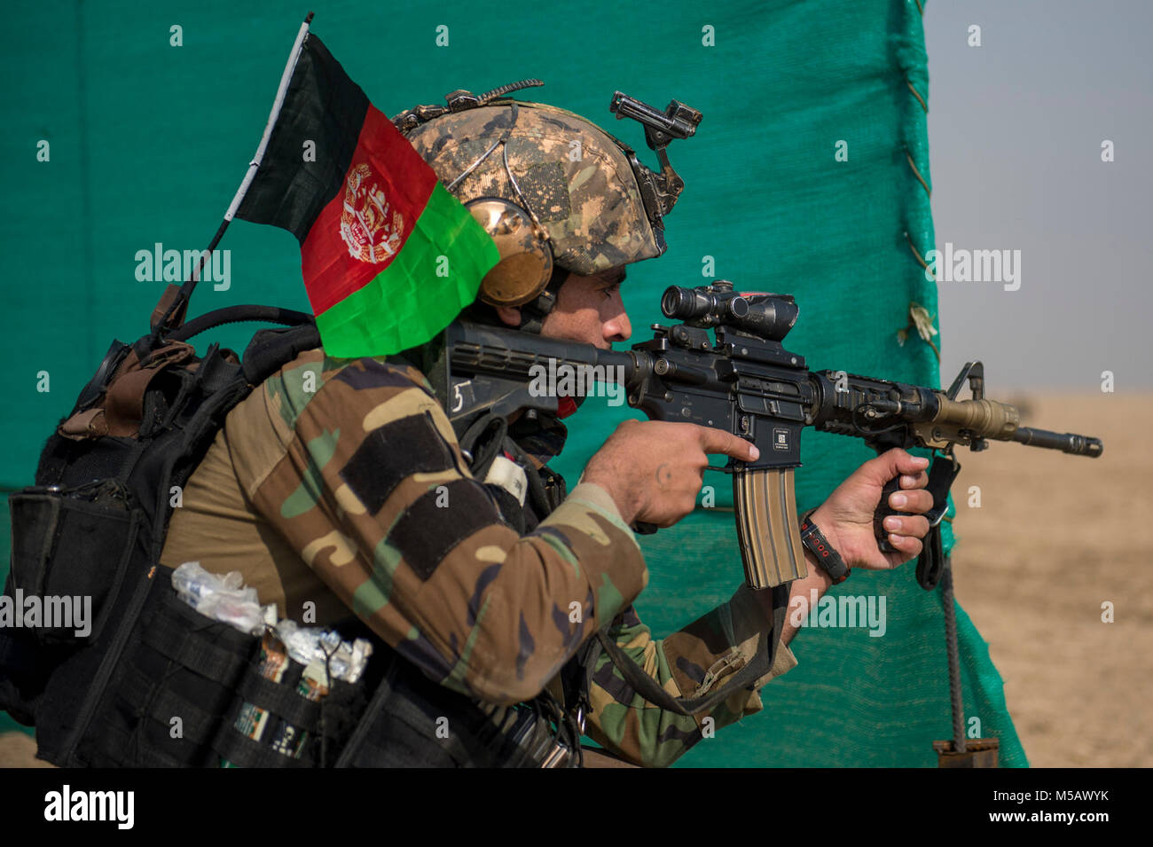 An Afghan Commando aims his weapon at a target during a training ...