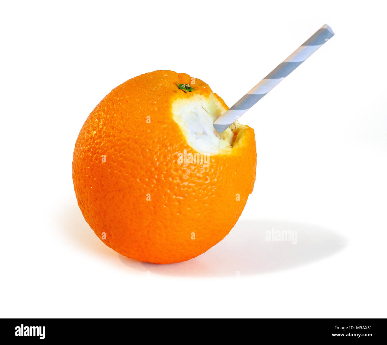 One orange partially peeled with straw inserted Stock Photo - Alamy