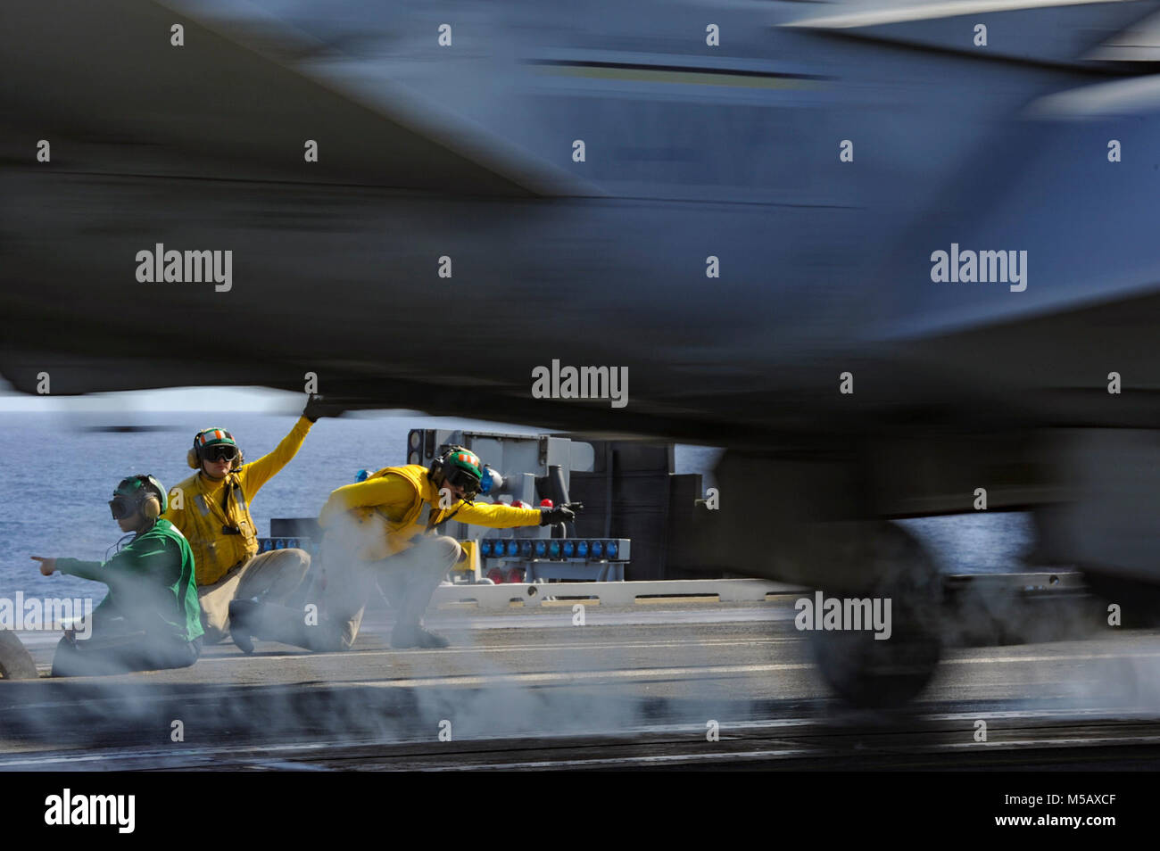 OCEAN (Feb. 12, 2018) Sailors signal for an F/A-18F Super Hornet ...
