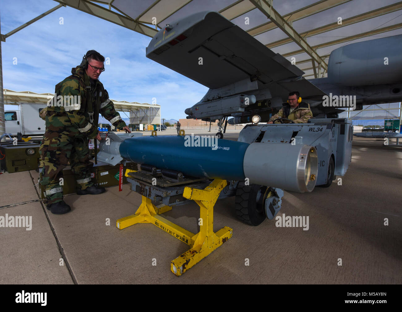 U.S. Airmen prepare to load a bomb onto an A-10C Thunderbolt II during ...