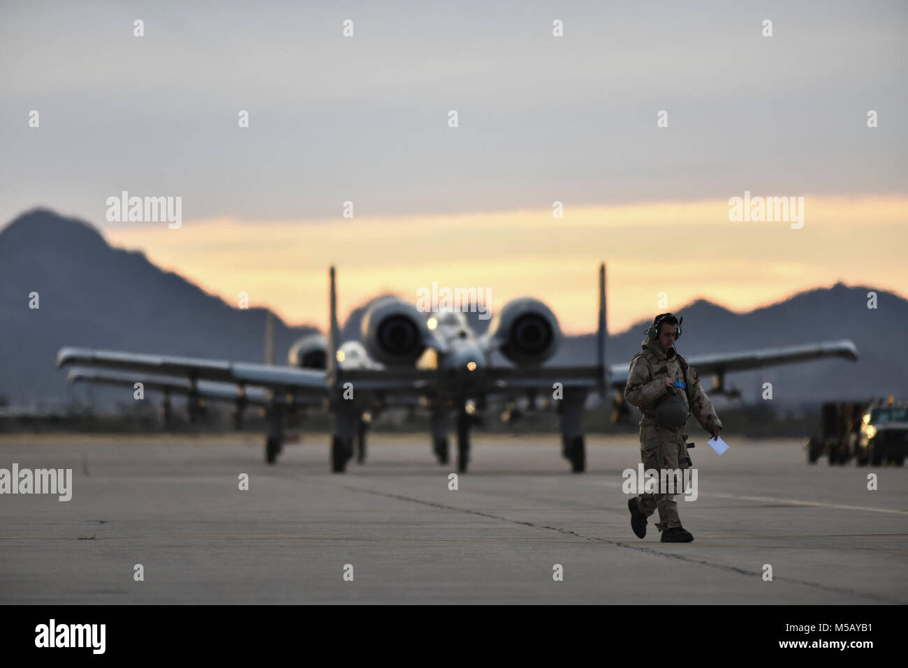 A U.S. Airman walks in the wake of two A-10C Thunderbolt IIs during the ...