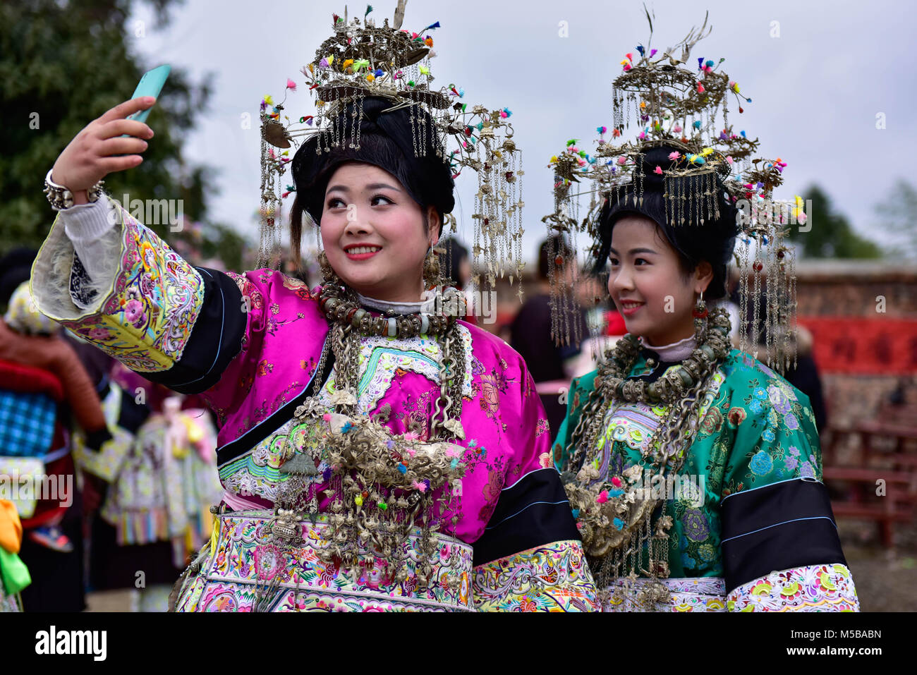 Qiandongnan, China. 21st Feb, 2018. Girls of Dong ethnic group take ...