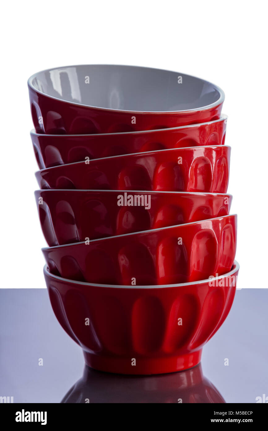 Stack of clean bright red ramekins for baking individual portions of a ...