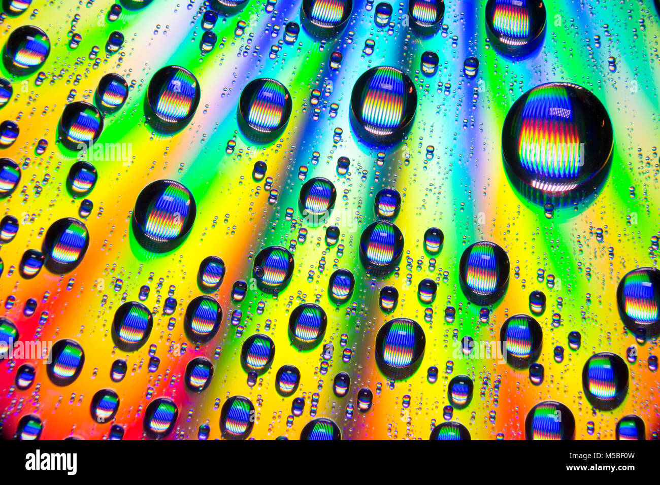 Water droplets on the shiny surface of a DVD. England UK GB Stock Photo ...