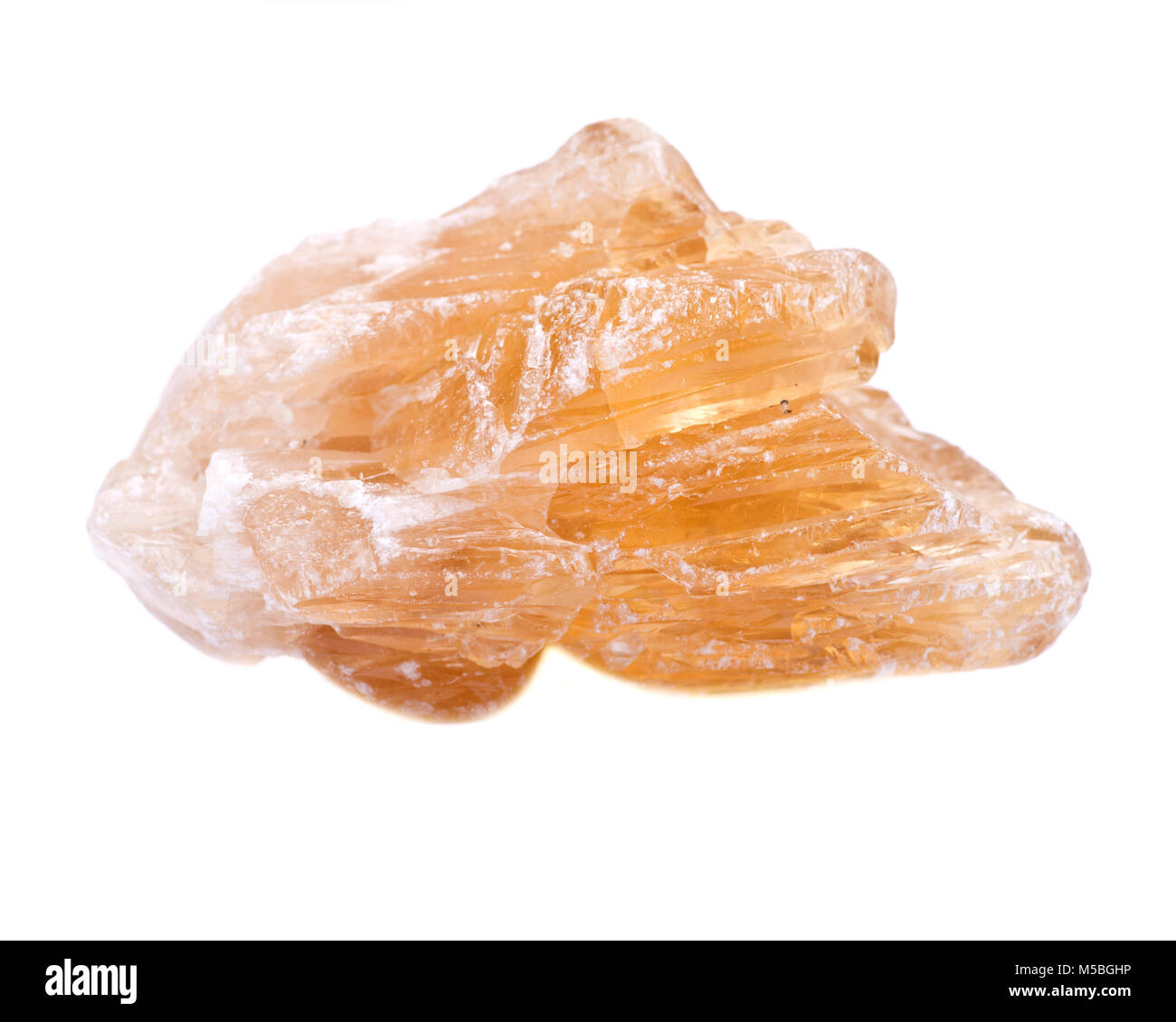 Partially crystallized golden Scapolite from Nigeria isolated on white ...