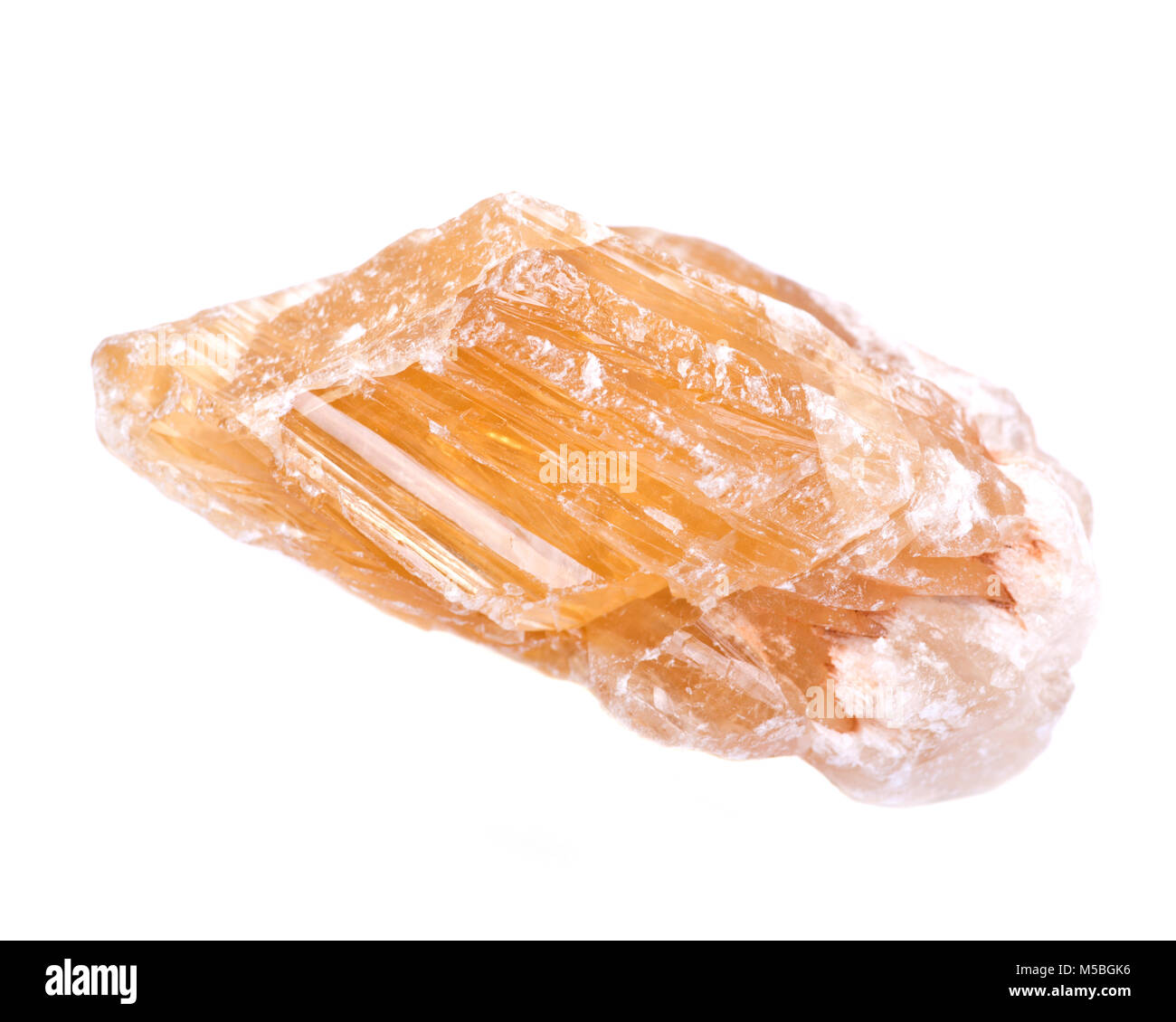 Partially crystallized golden Scapolite from Nigeria isolated on white ...