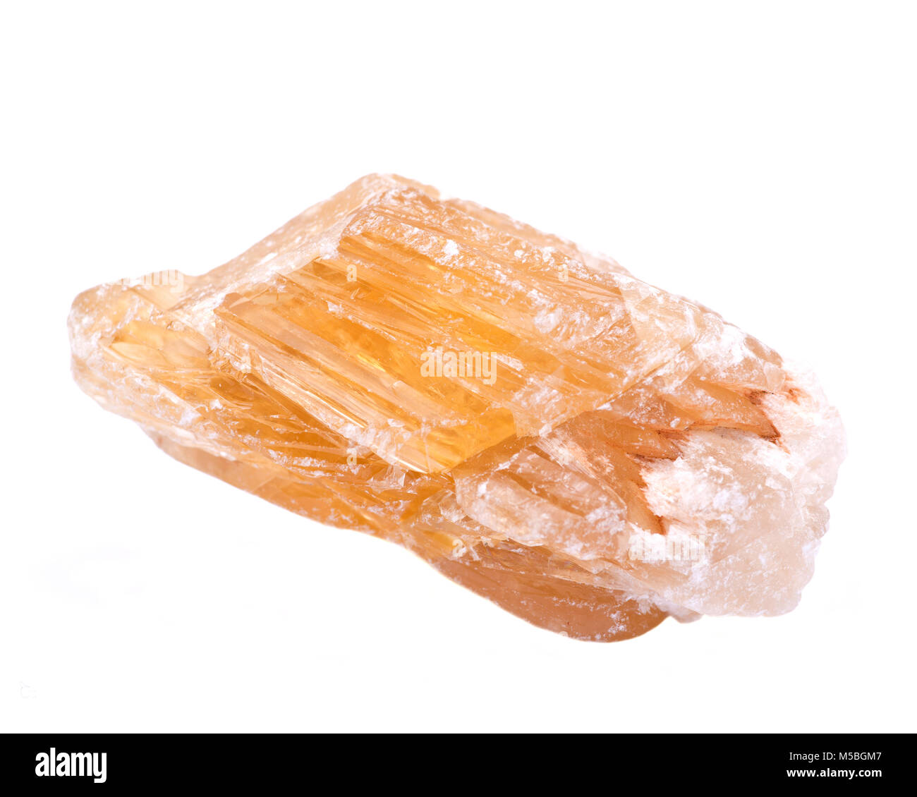 Partially crystallized golden Scapolite from Nigeria isolated on white ...