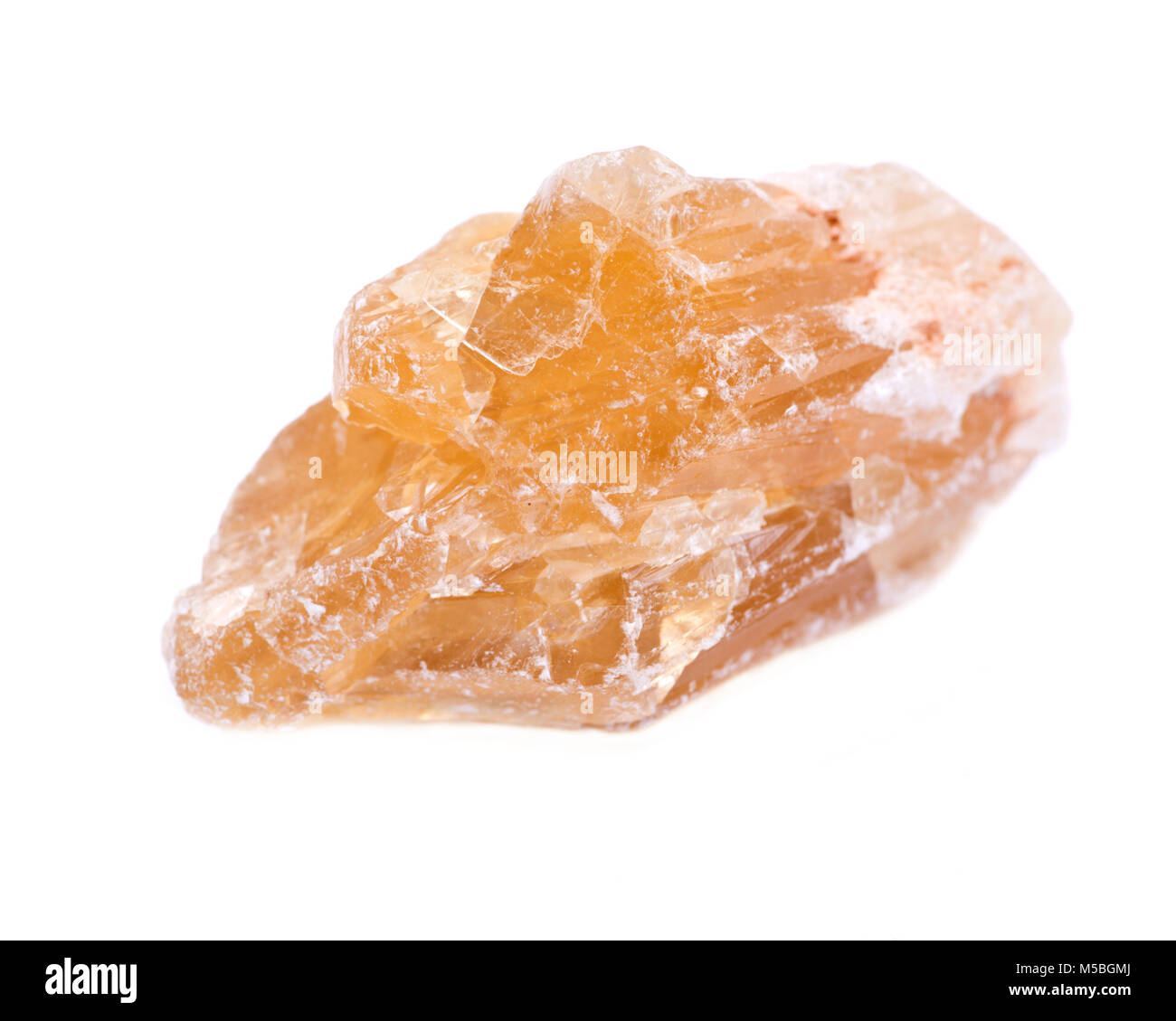 Partially crystallized golden Scapolite from Nigeria isolated on white ...