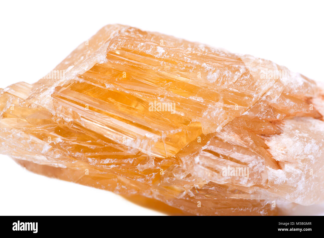 Partially crystallized golden Scapolite from Nigeria isolated on white ...
