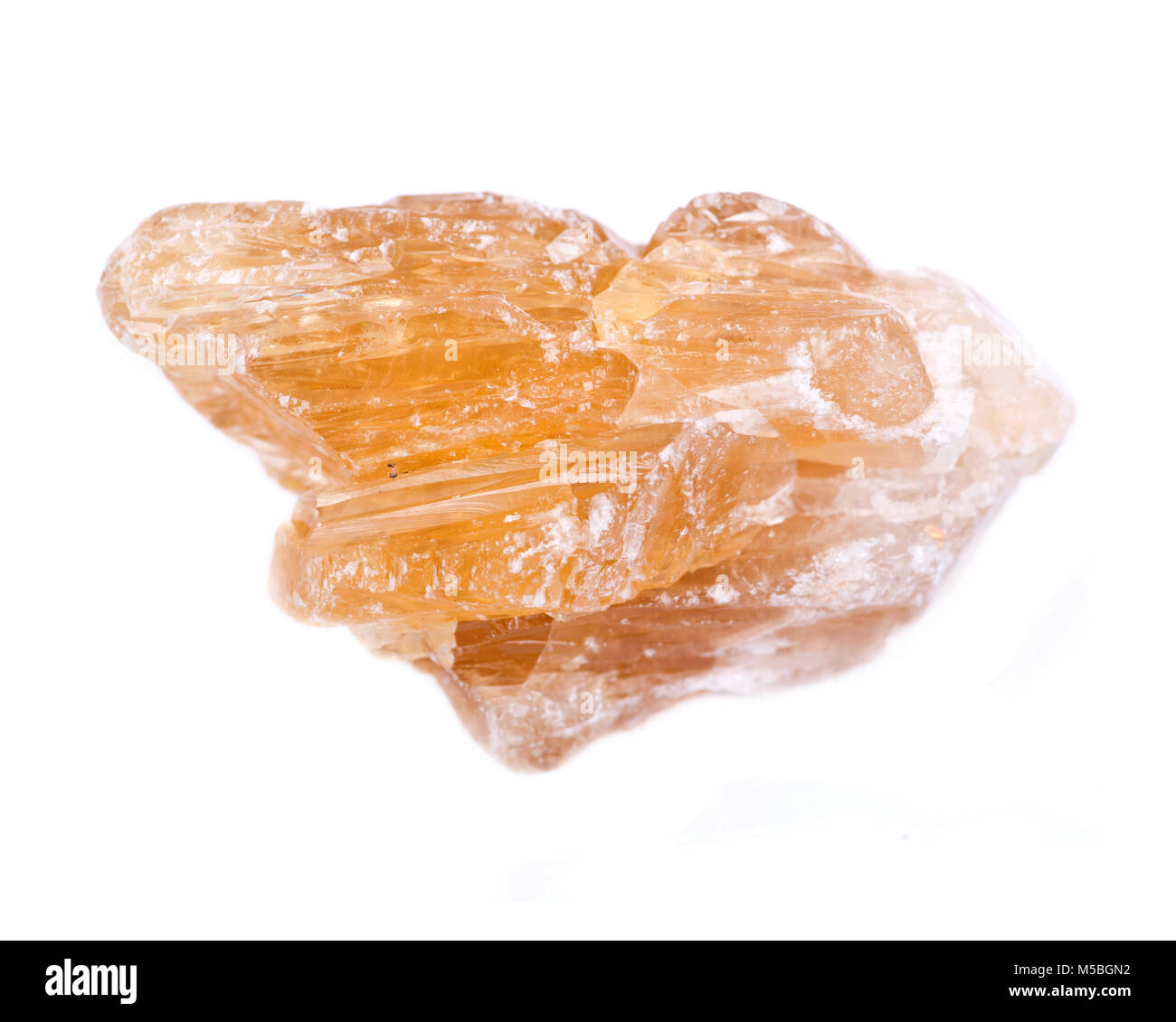 Partially crystallized golden Scapolite from Nigeria isolated on white ...