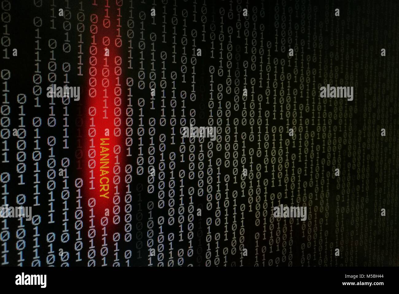 computer virus. binary data shown on black screen with wannacry text ...