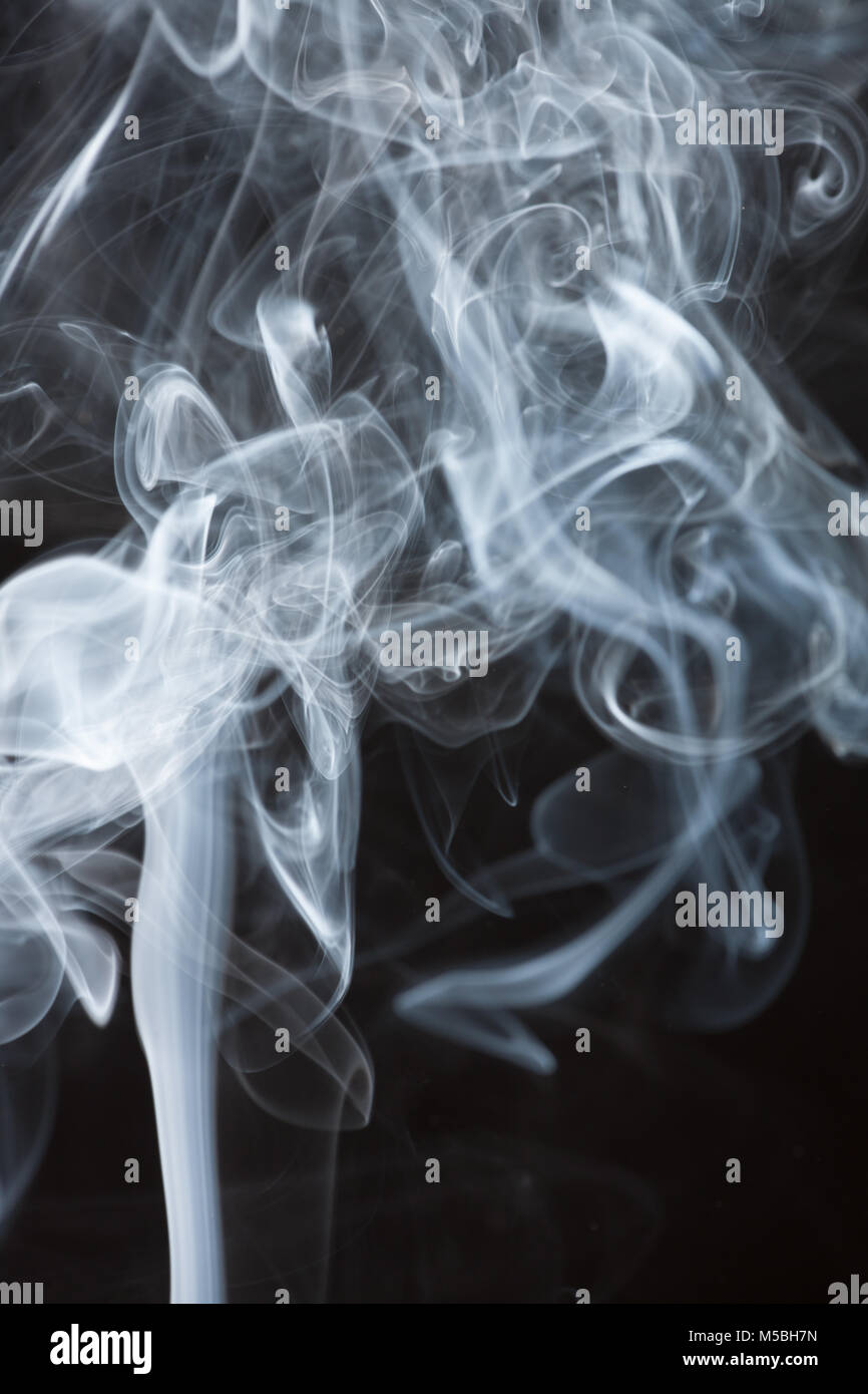 Smoke patterns on black background Stock Photo - Alamy