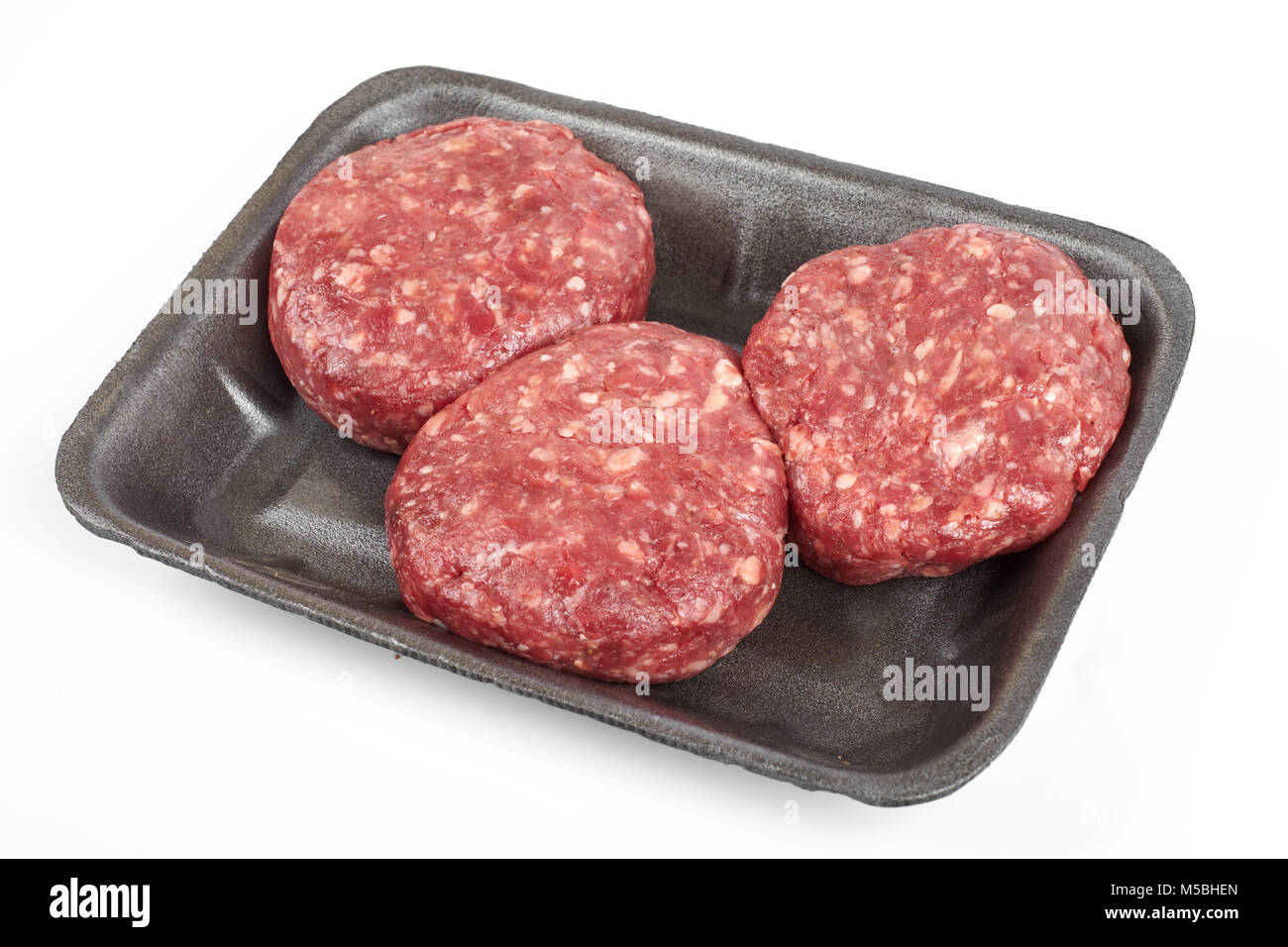 Tray with raw beef burgers or minced meat isolated on white background ...