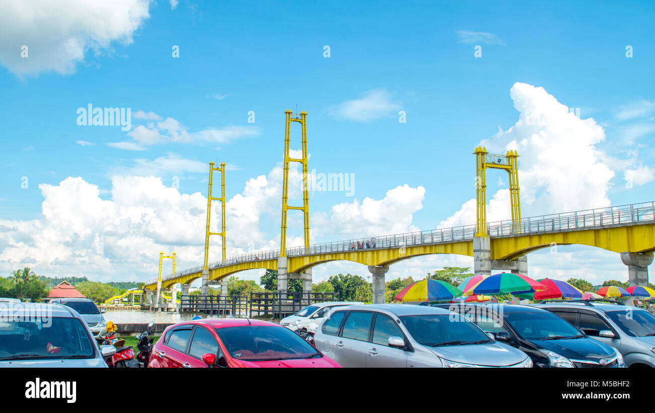 cars parking with yellow bridge as the background Stock Photo - Alamy