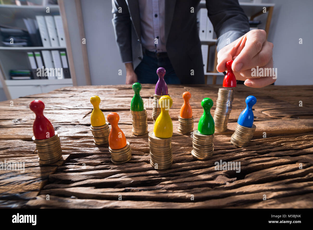 Close-up Of A Businessperson's Hand Placing Red Figurine Pawn On Top Of ...