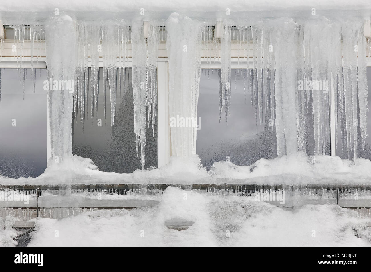 Icicle windows on winter time. Freeze temperatures backgrounds ...