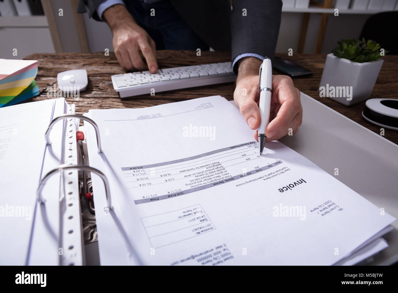 Close-up Of A Businessperson's Hand Checking Bill On Wooden Desk Stock ...