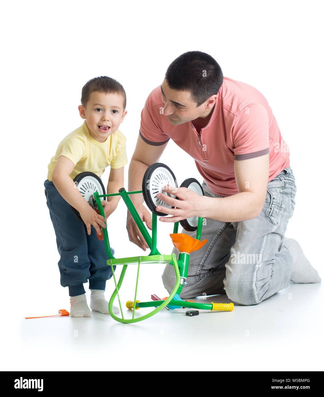 Father repairing children bicycle with his child son Stock Photo - Alamy