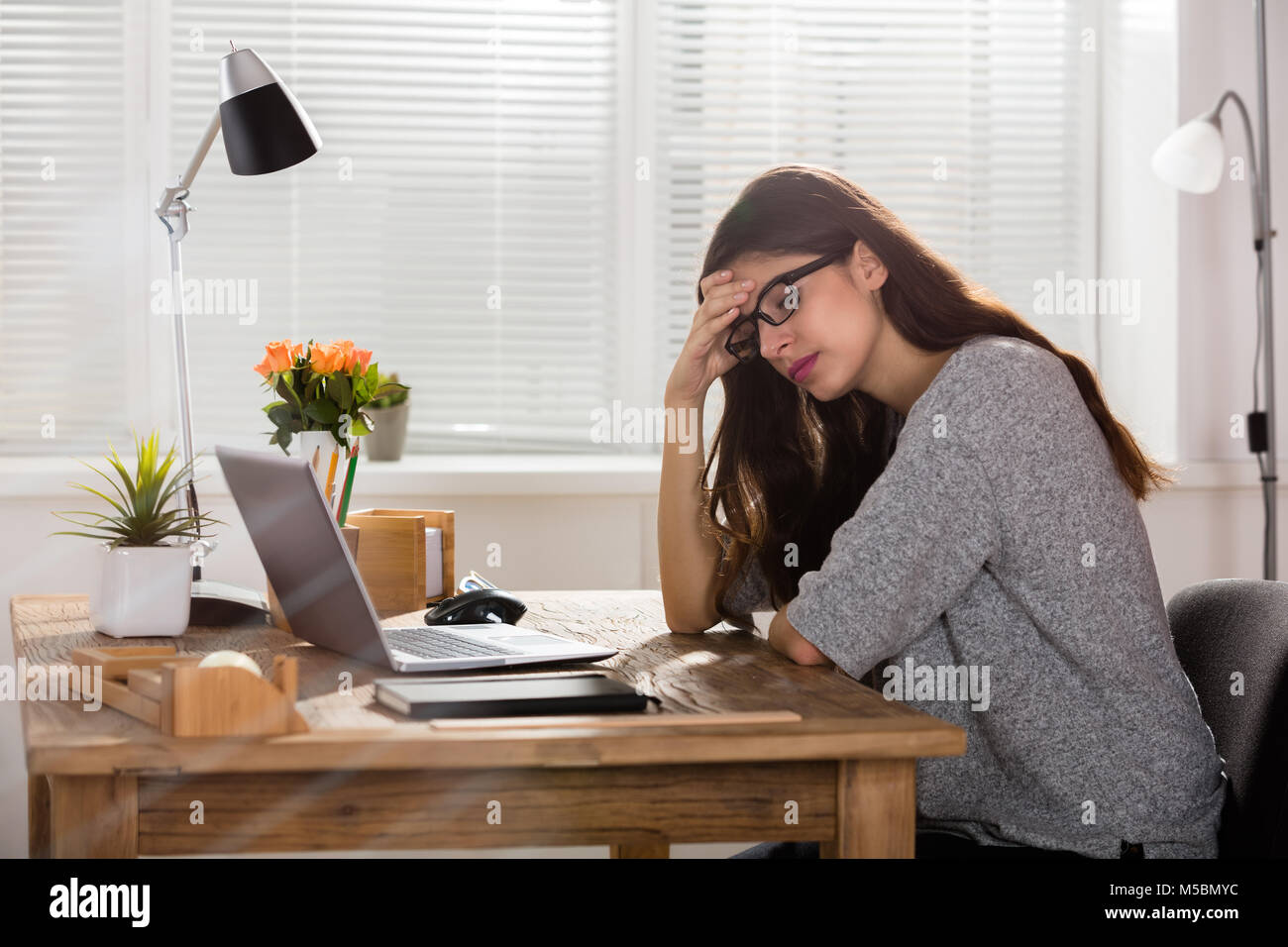 Sad Depressed Young Businesswoman Sitting In Office Stock Photo - Alamy