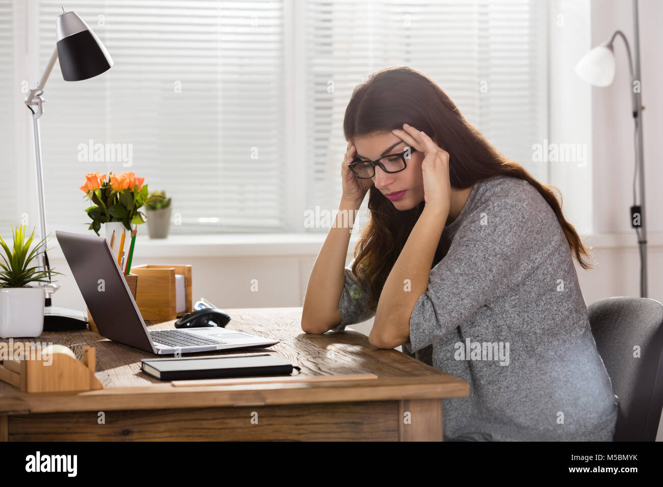 Sad Depressed Young Businesswoman Sitting In Office Stock Photo - Alamy