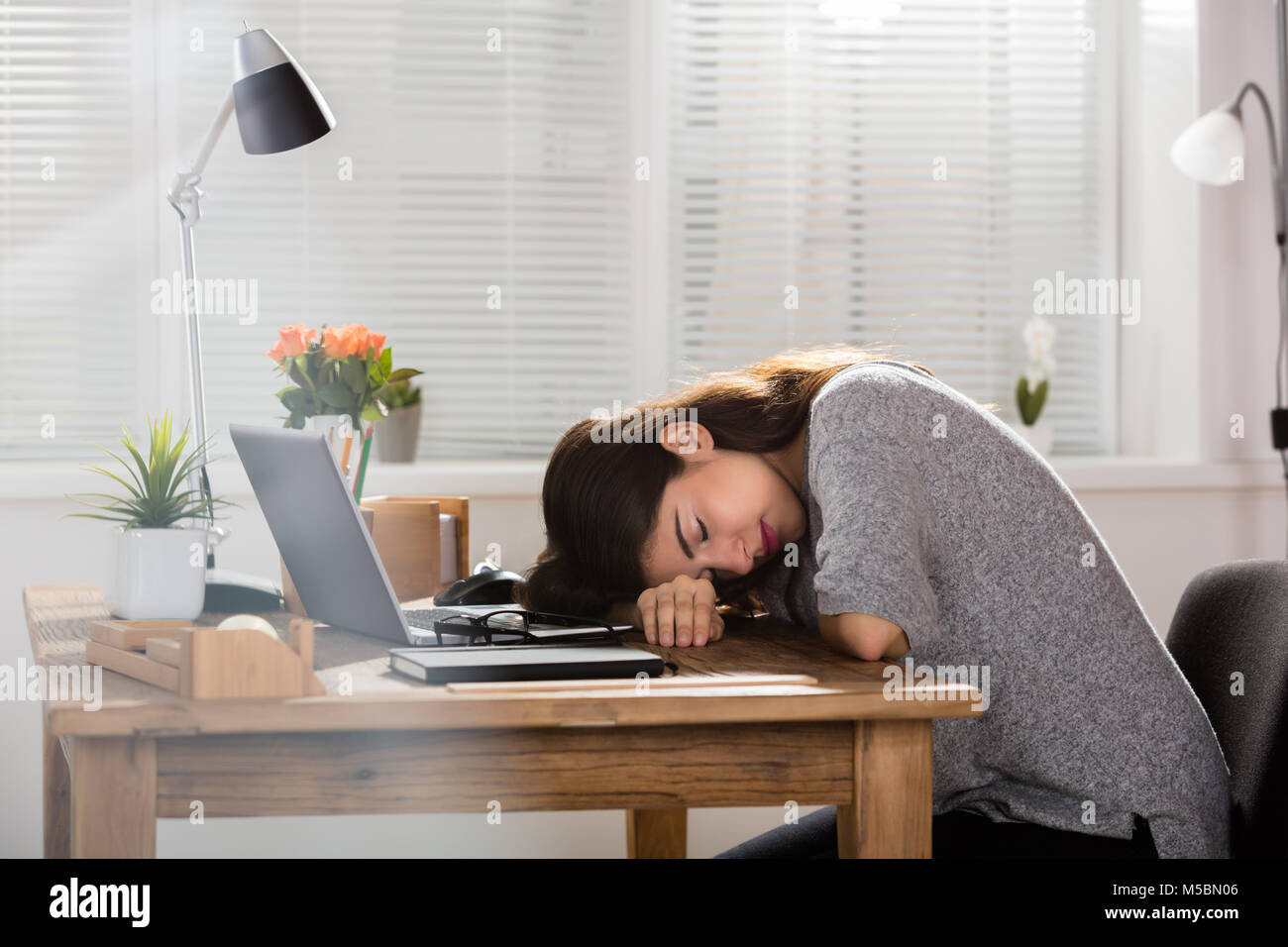 Close-up Of A Young Businesswoman Sleeping On Office Desk Stock Photo ...
