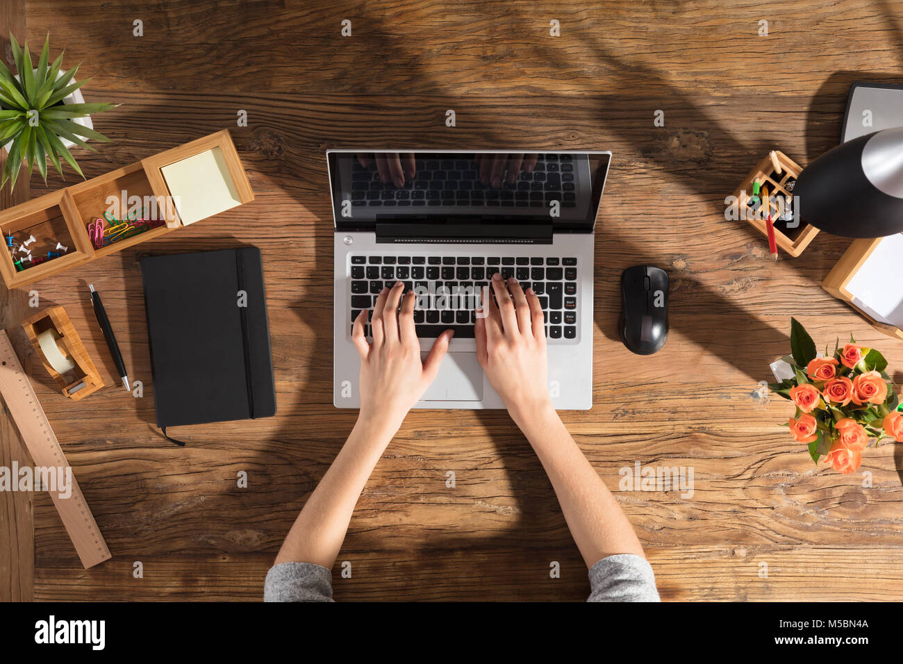 Close-up Of A Person Using Laptop Computer On Office Wooden Desk Stock ...
