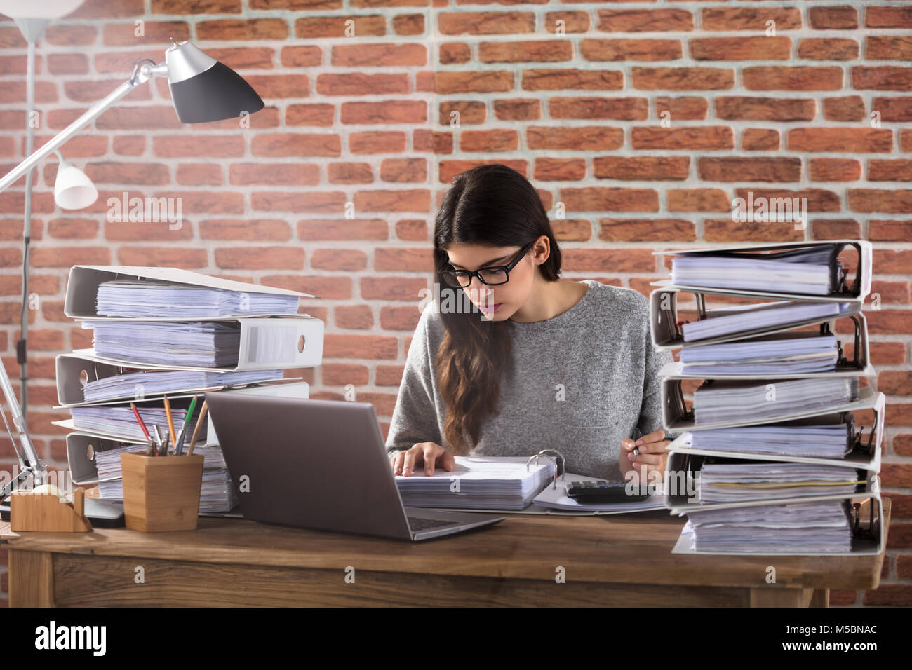 Business woman laptop stack file hi-res stock photography and images ...