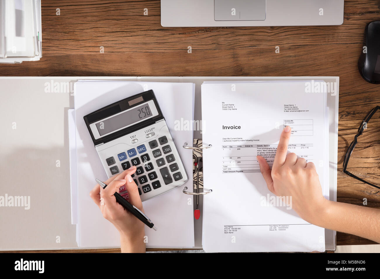 Close-up Of A Businessperson Calculating Invoice Using Calculator On ...