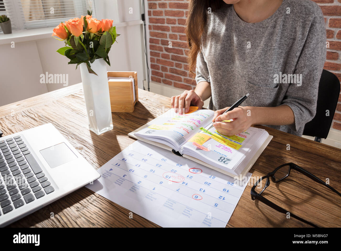 Close-up Of A Businesswoman Making Agenda On Personal Organizer At ...