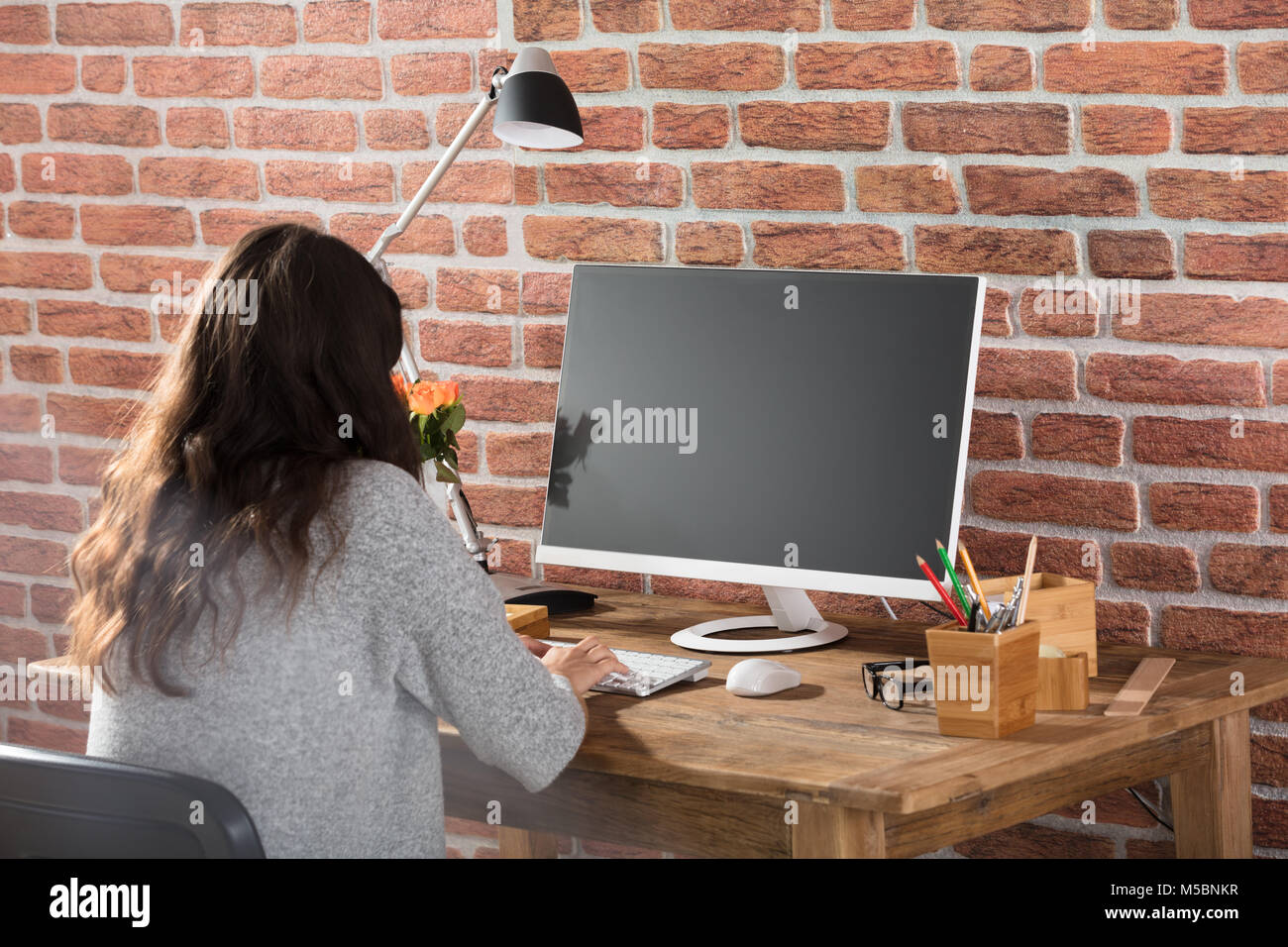 Rear View Of A Woman Using Computer Stock Photo - Alamy