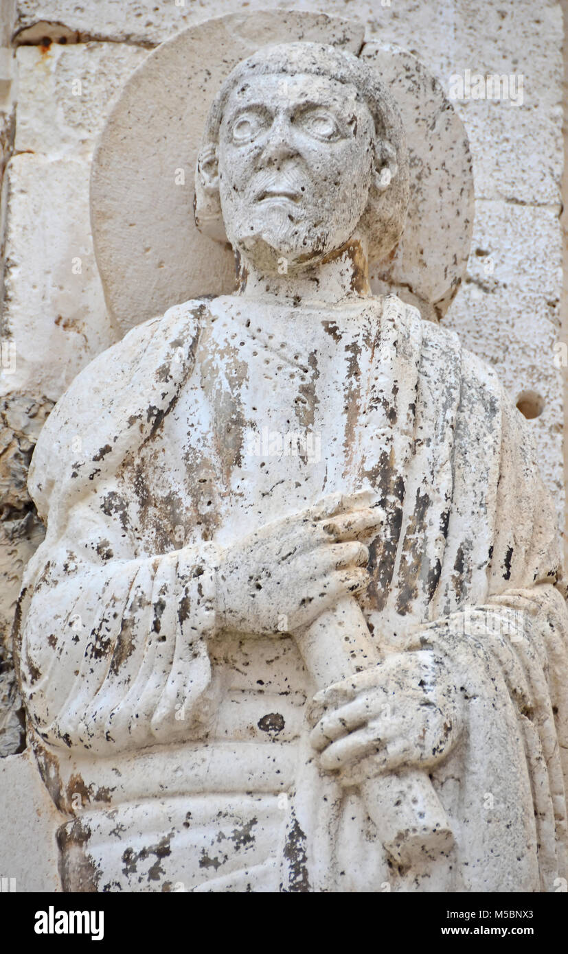 Medieval sculpture of the evangelist Saint John holding his scripture ...
