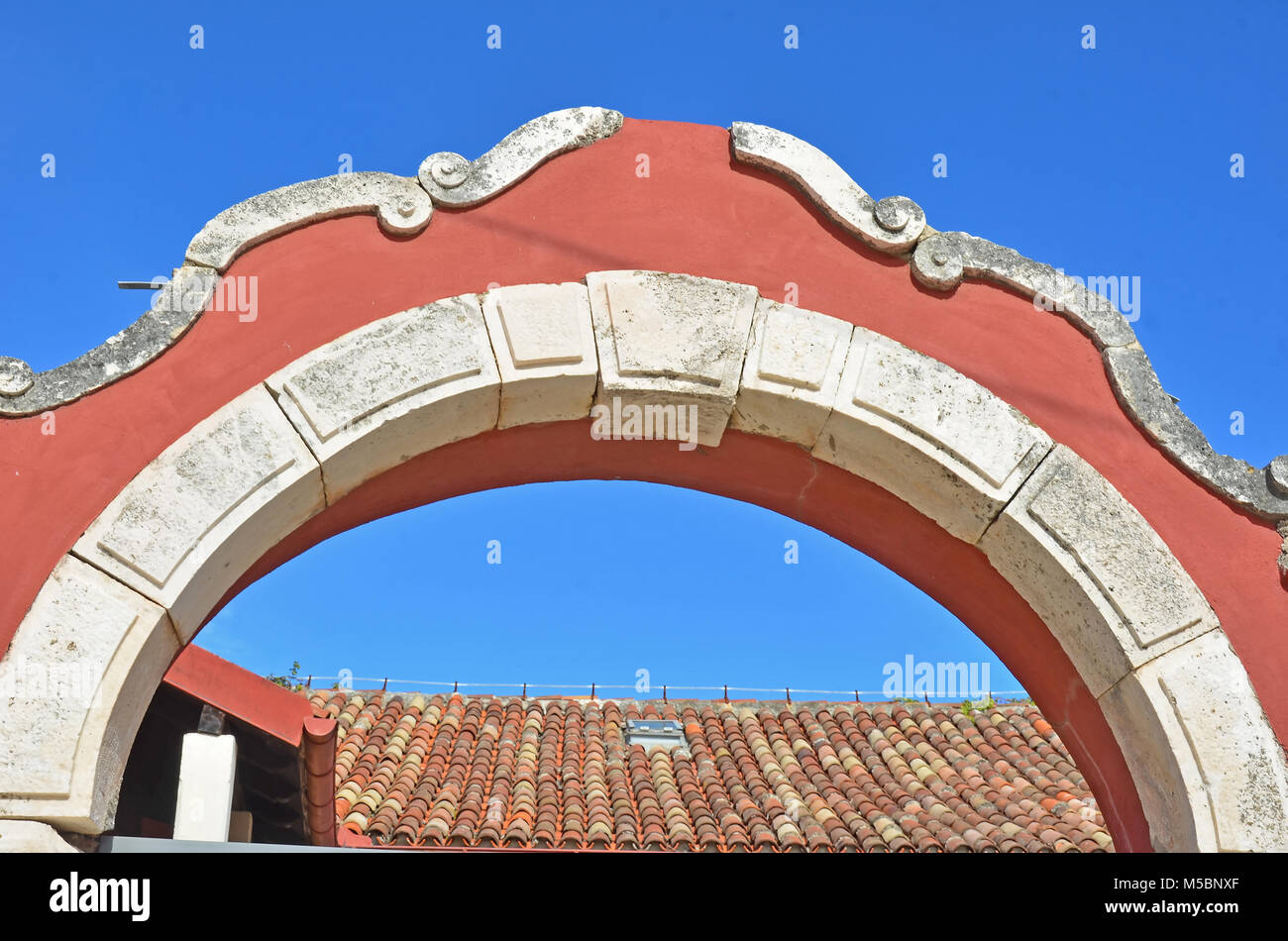 Stone arch in baroque style with red plaster over a gateway Stock Photo ...