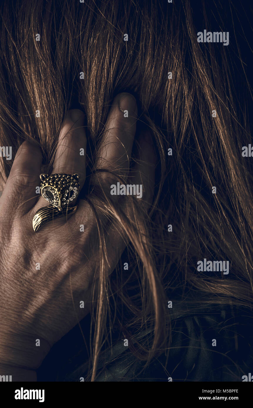 woman with fingers tangled in hair ,wearing fox shaped ring Stock Photo ...