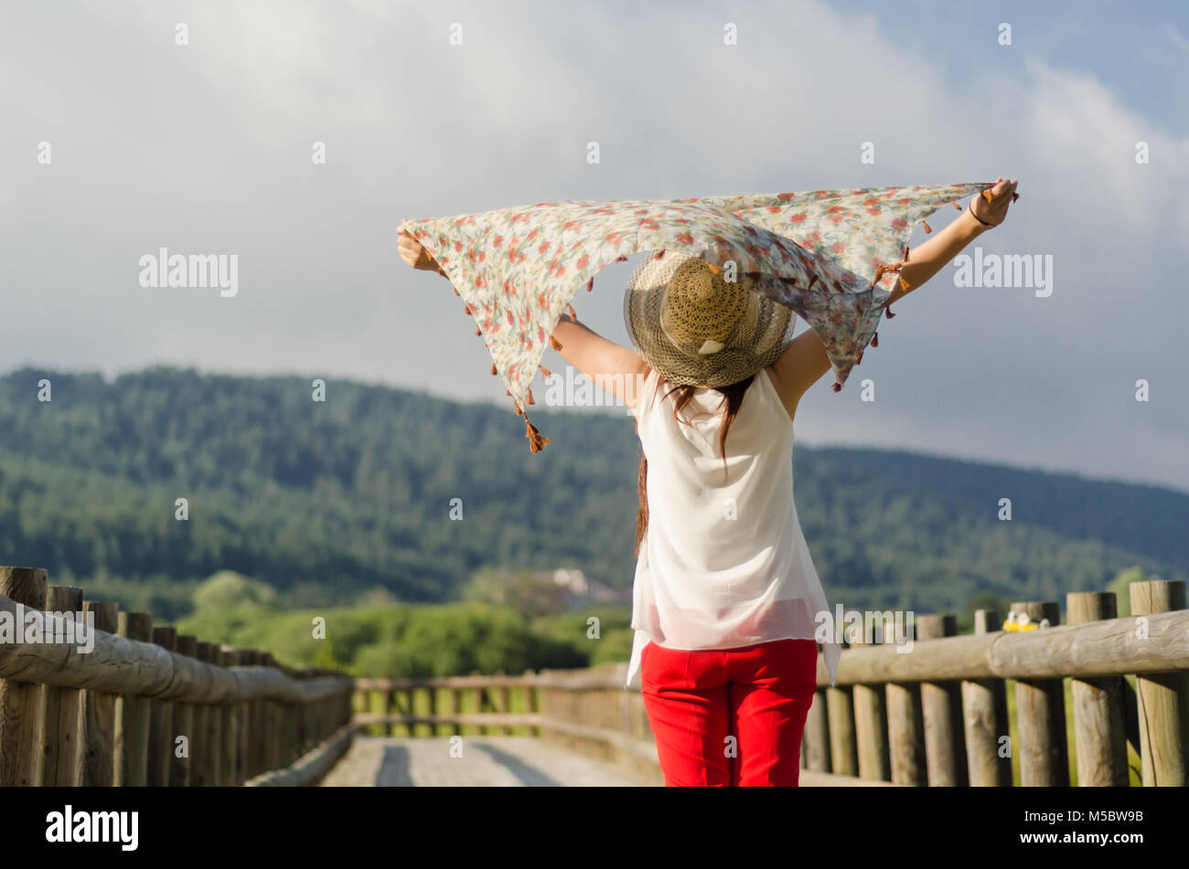 the young woman who turned his face in the wind, raised his hands up ...