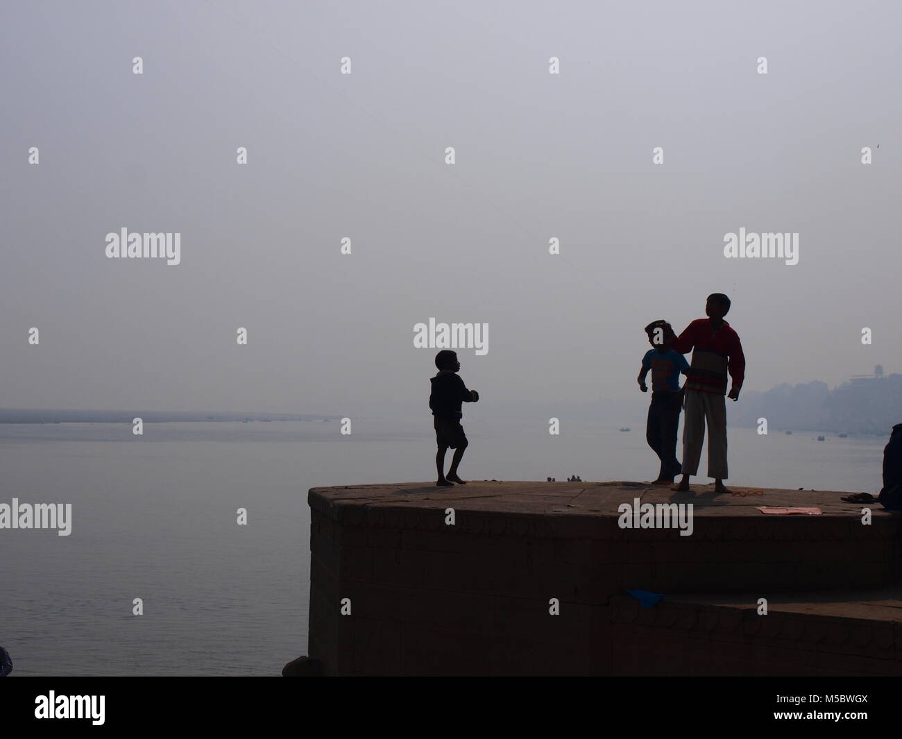 Boys playing by the river Ganges Stock Photo - Alamy