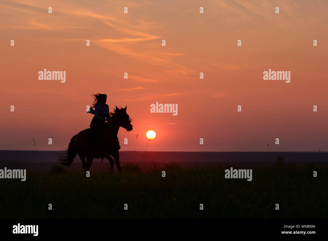 Galloping horse on sunset. Horseback woman riding gallop with red ...