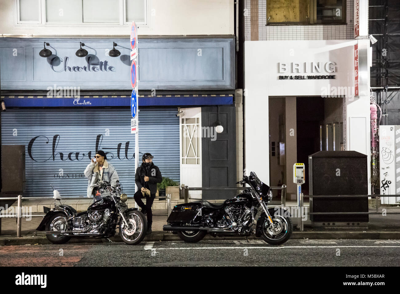 Two bikers hang out with their motorcycles Stock Photo - Alamy