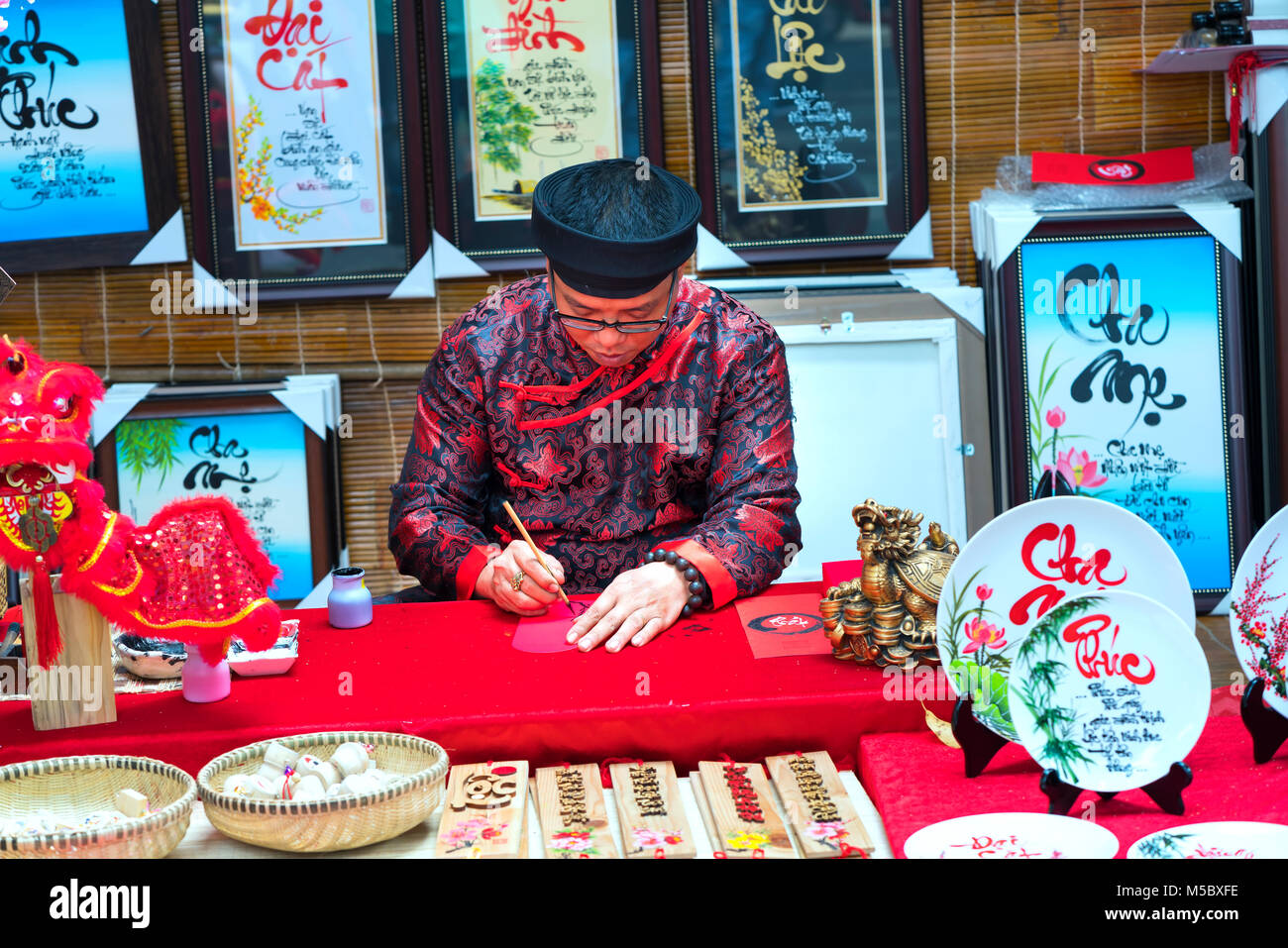 Vietnamese scholar writes calligraphy at lunar new year calligraphy ...