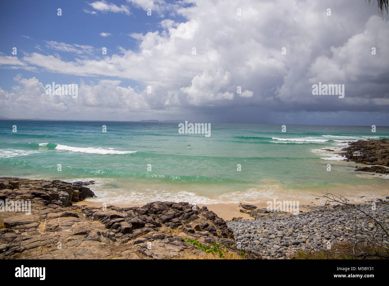 Distant storm on Australian beach Stock Photo - Alamy