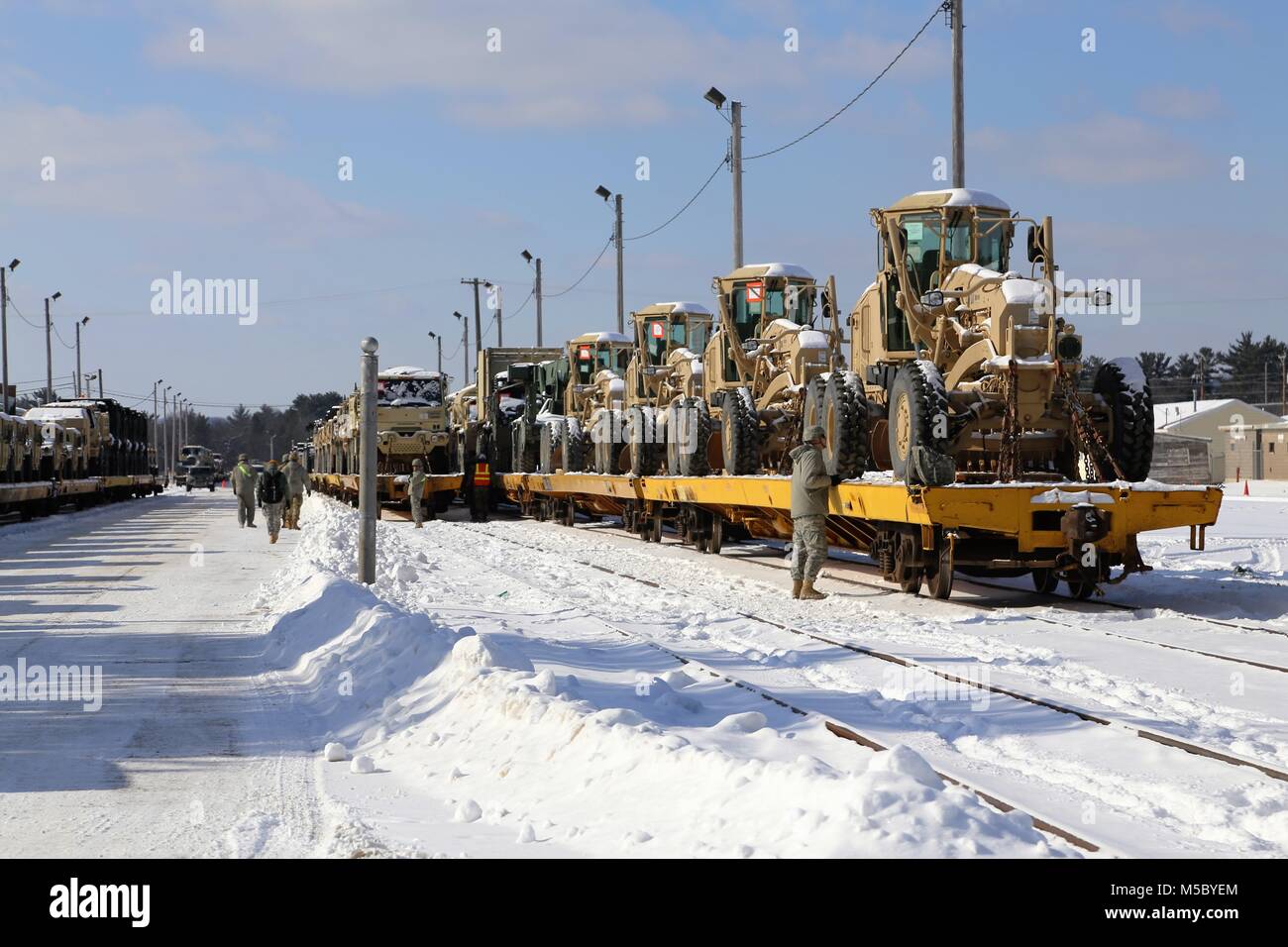 Soldiers prepare military equipment on railcars for shipment Feb. 7 ...