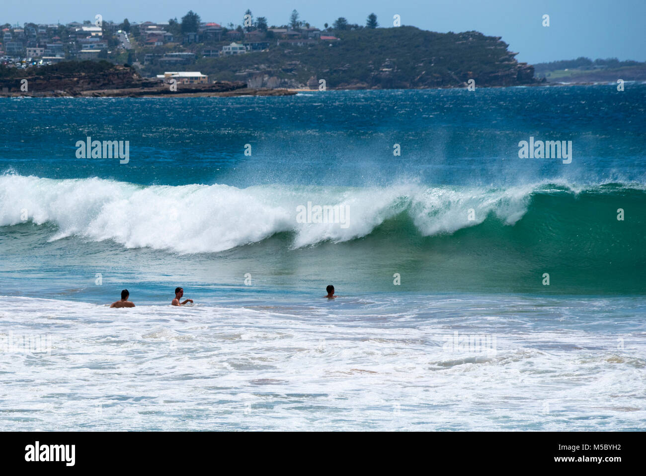 Breakng wave on Manly Beach on a summer day with blue sky, Sydney ...