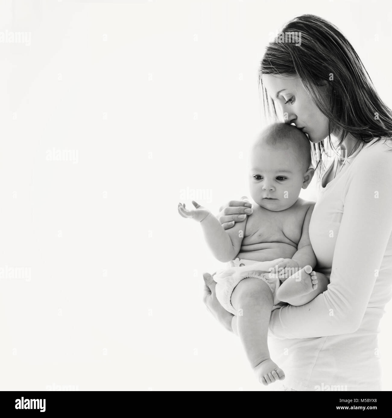 Mother, holding her sick baby boy, sad baby, isolated on white ...