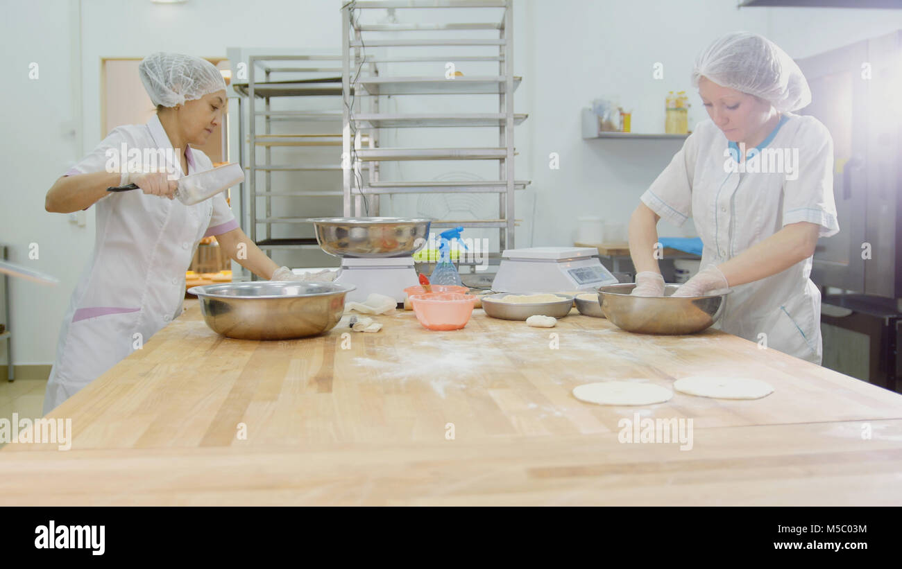 The employees women in the bakery makes fresh bread Stock Photo - Alamy