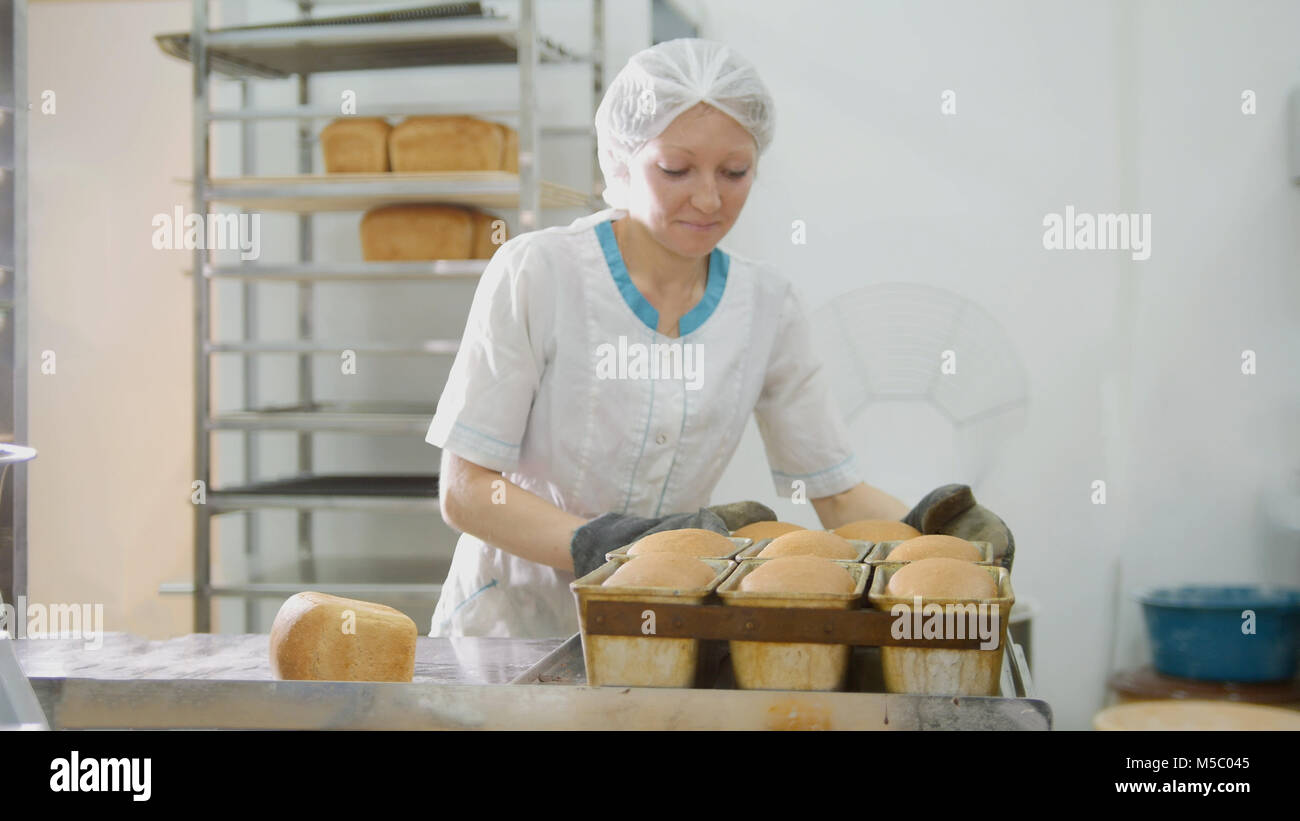 Woman bakes bread on commercial kitchen Stock Photo - Alamy