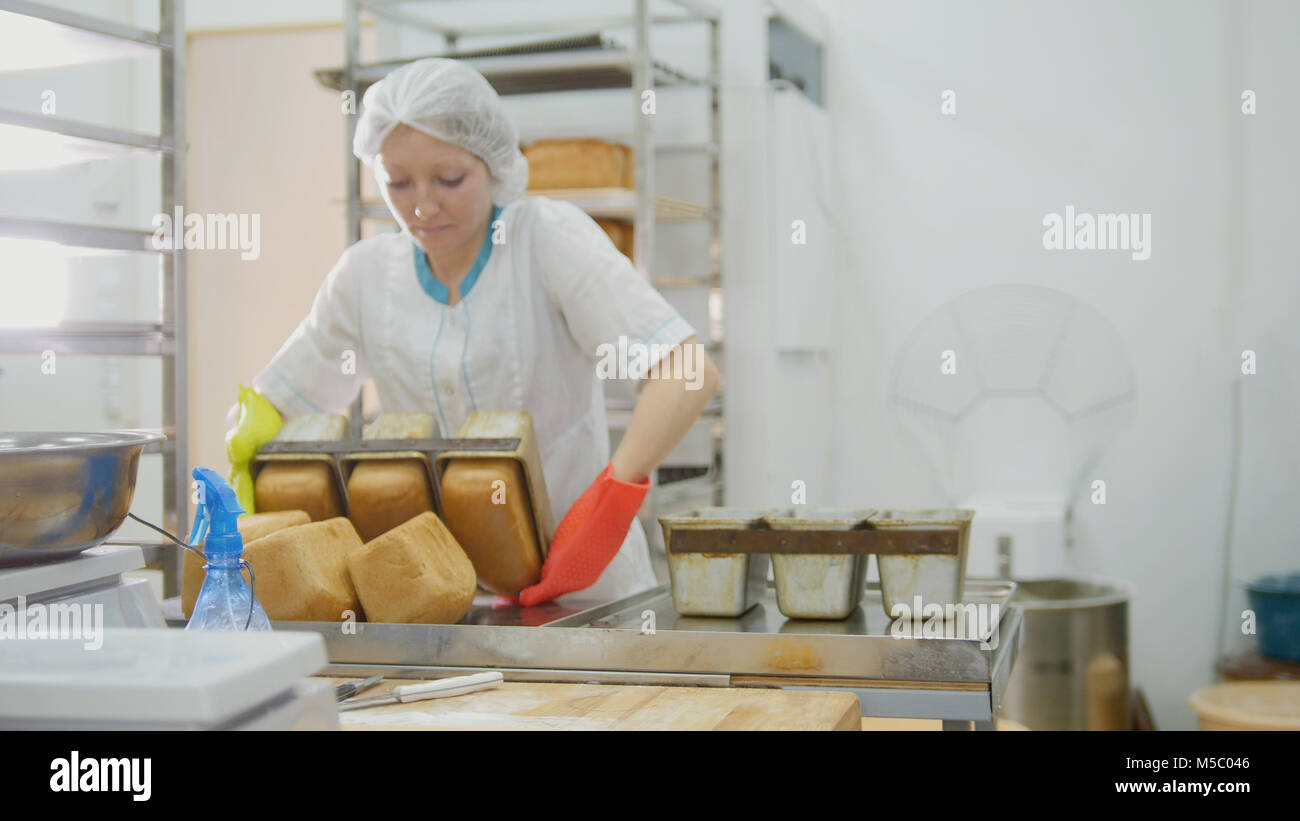 Female bakes bread on commercial kitchen Stock Photo - Alamy