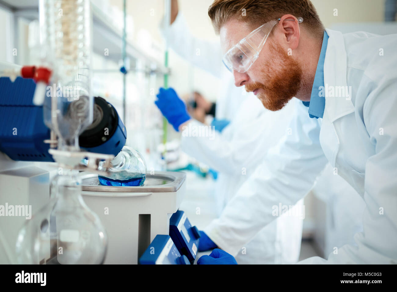 Attractive student of chemistry working in lab Stock Photo - Alamy