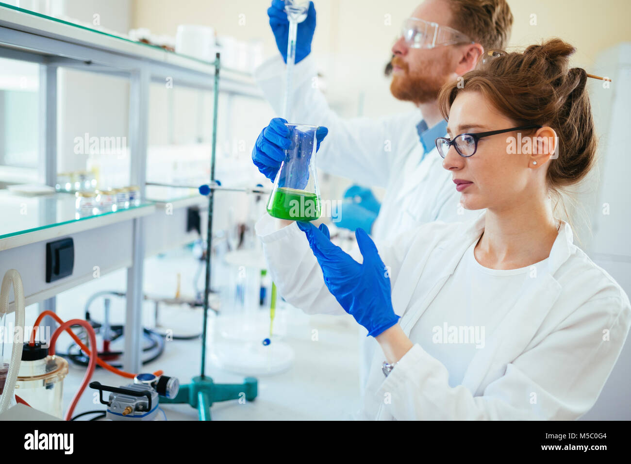 Group of students working at the laboratory Stock Photo - Alamy